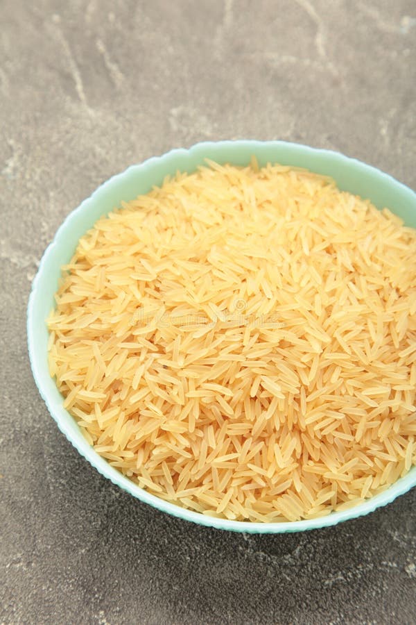 Rice Grains on Mint Plate on Grey Concrete Background. Vertical Photo ...