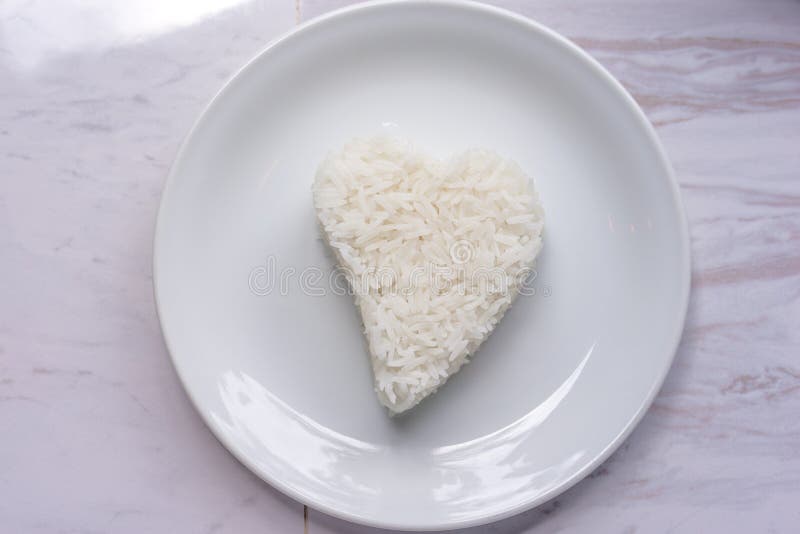 Rice on heart shaped board stock photo. Image of grain - 22123036