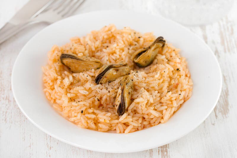 Rice with mussels on plate stock photo. Image of seasonal - 41296108
