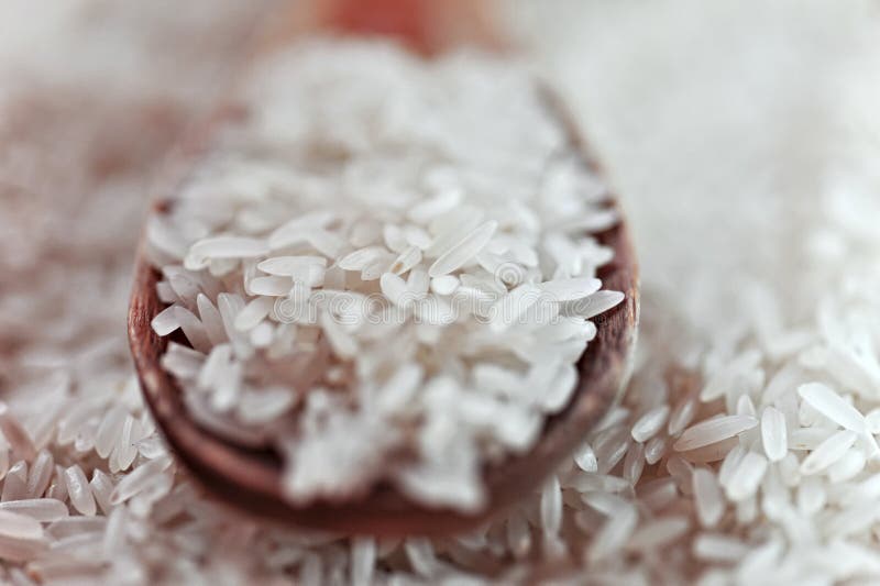 Rice on the Table Being Handled by a Wooden Spoon Stock Image - Image ...