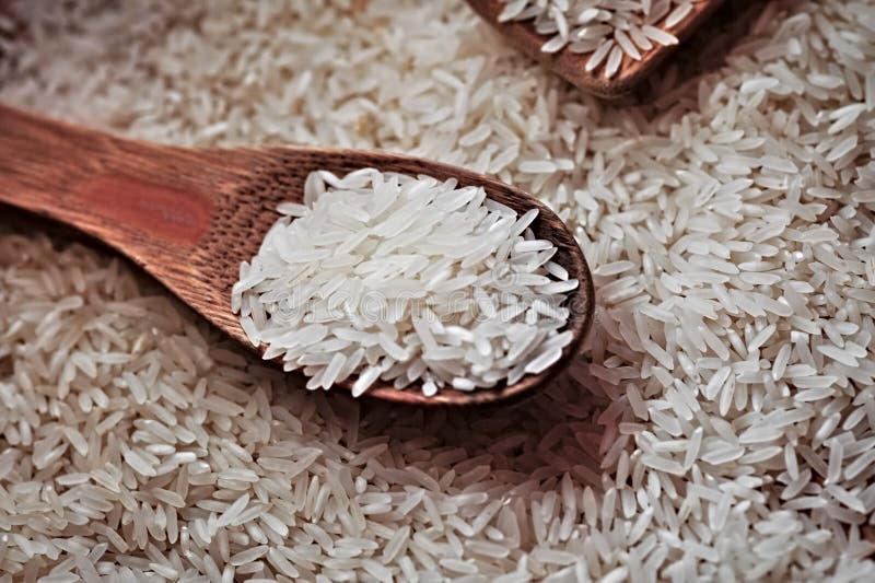 Rice on the Table Being Handled by a Wooden Spoon Stock Photo - Image ...