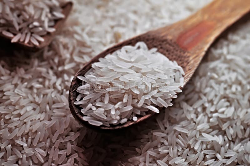 Rice on the Table Being Handled by a Wooden Spoon Stock Photo - Image ...