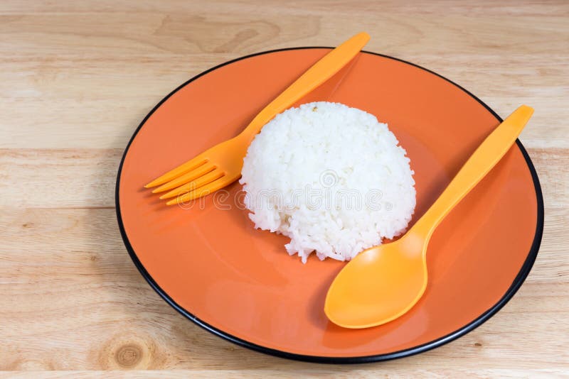 Rice on Orange Dish with Spoon on Wood Table Stock Image - Image of ...