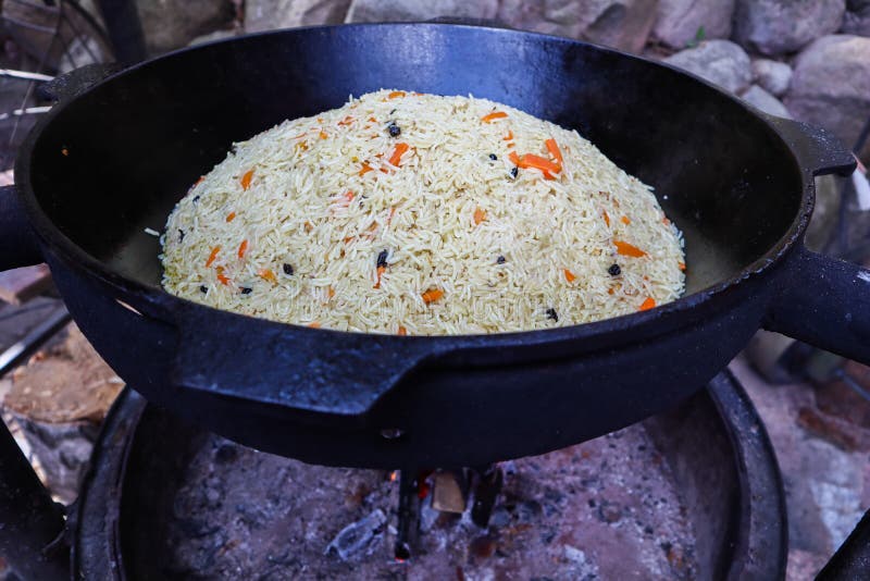 Rice Pilaf in a Large Cast-iron Cauldron on Fire Stock Photo - Image of ...