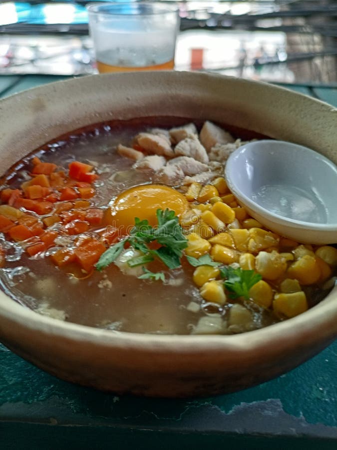 Rice Porridge on a Ceramic Bowl with Vegetable Topping and Raw Egg ...