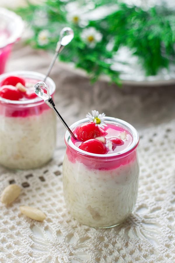 Rice Pudding with Almonds, Whipped Cream and Cherry Sauce Stock Photo ...