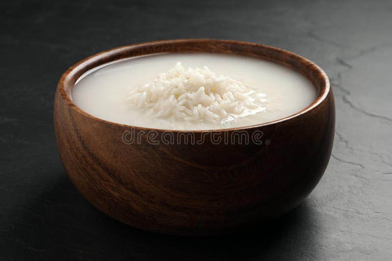 Rice Soaked in Water on Black Table, Closeup Stock Photo - Image of ...
