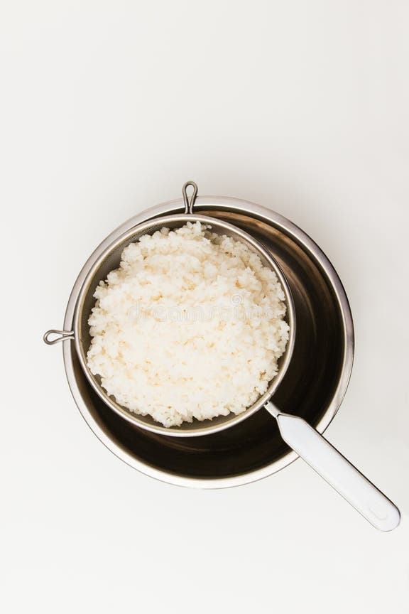 Rice in strainer stock photo. Image of background, dinner - 242852140