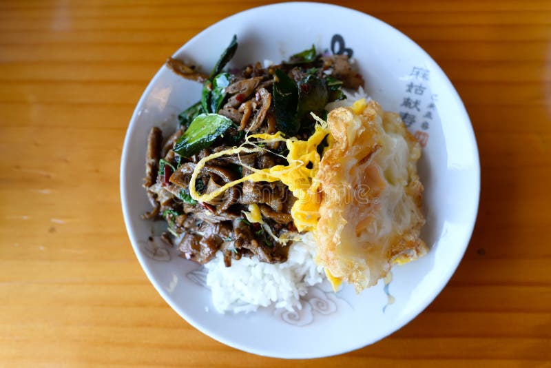 Rice Topped with Stir-fried Basil Duck and Fried Egg. Stock Photo ...