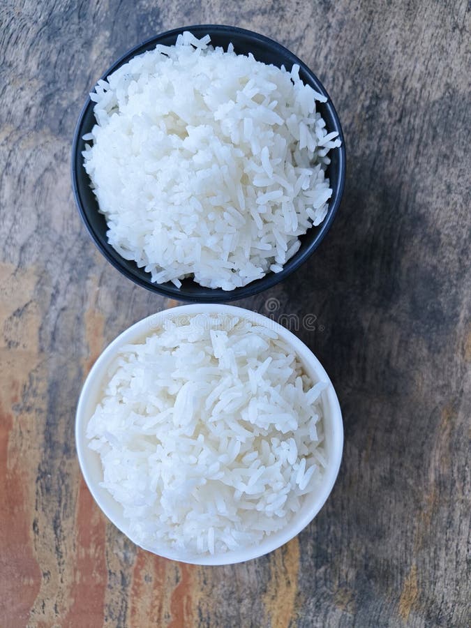 Rice in a White Bowl and Black Bowl on an Old Wood Stock Image - Image ...