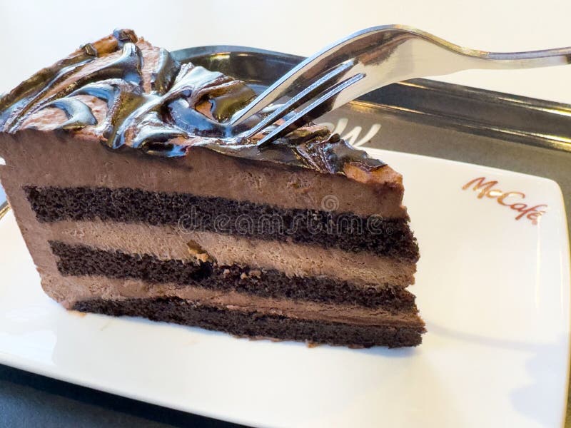 Rich Chocolate Layer Cake with Fork on M Mccafe Plate Editorial Stock ...