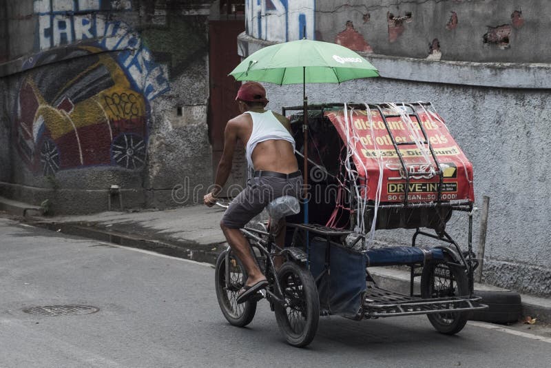 Rickshaw Driver Rides Away in an Empty Street of Manila, the ...
