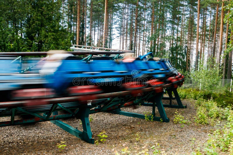 Ride Roller Coaster in Motion in Amusement Park at Summer Day Stock ...