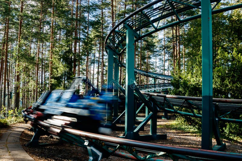 Ride Roller Coaster in Motion in Amusement Park at Summer Day Stock ...