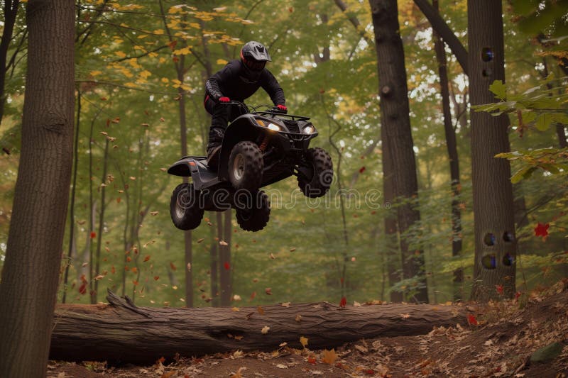 Rider Jumping Atv Over a Forest Log, Leaves Fluttering Down Stock Image ...