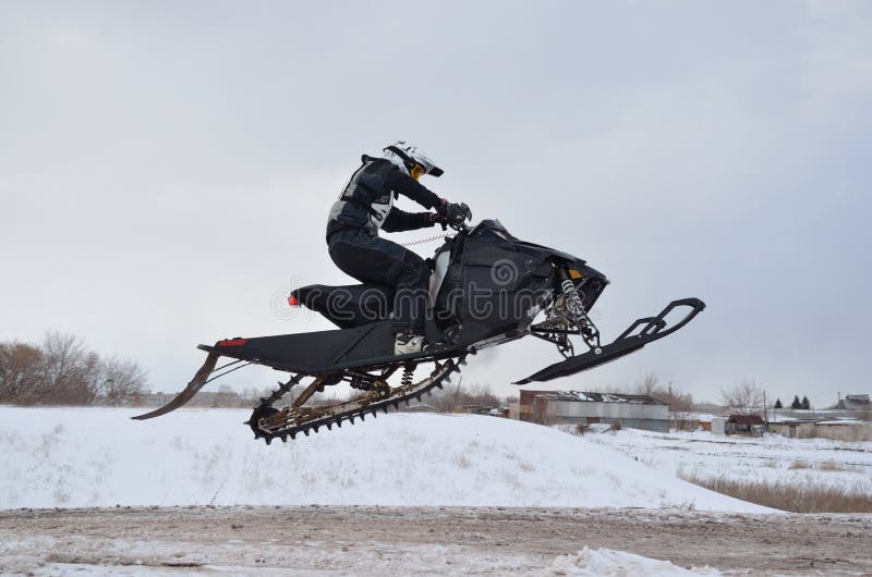 Snowmobile Rider Jumping stock photo. Image of adrenaline - 4868480