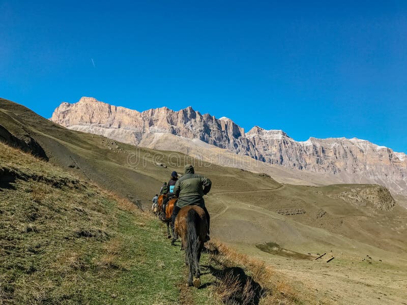 Riders on Horseback Ride in the Mountains during the Daytime Rear View ...