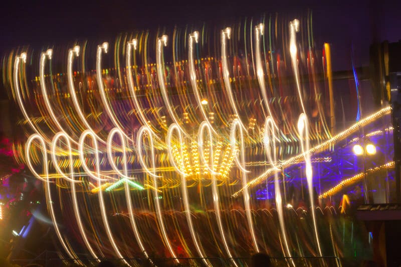 Rides in Motion at the Amusement Park, Night Illumination. Long ...