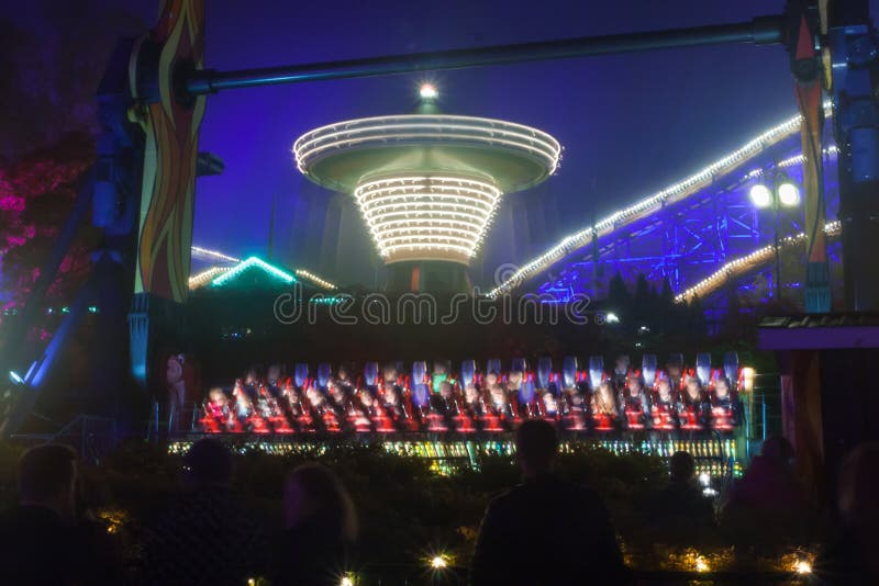 Rides in Motion at the Amusement Park, Night Illumination. Long ...