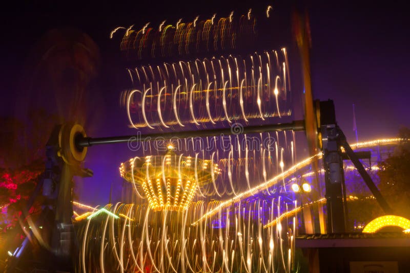 Rides in Motion at the Amusement Park, Night Illumination. Long ...