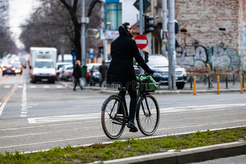 Riding a Bicycle on the City Streets. Commute To Work in Bucharest ...