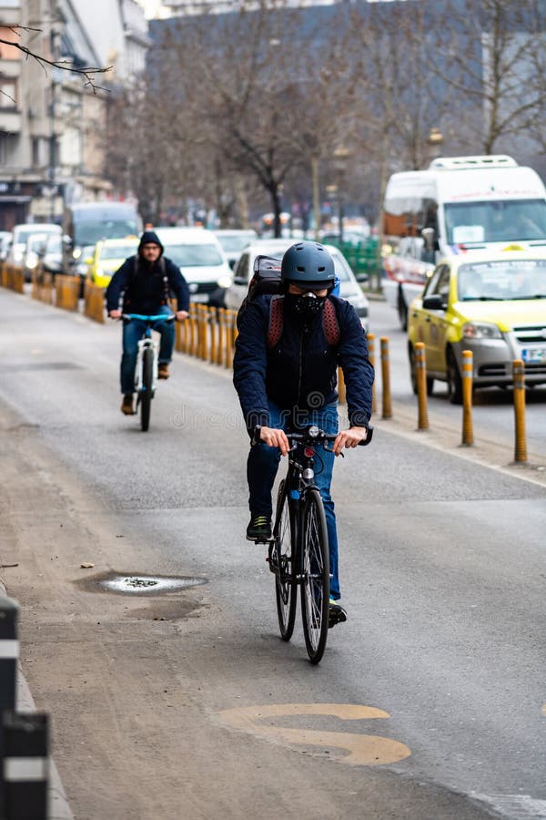 Riding a Bicycle on the City Streets. Commute To Work in Bucharest ...