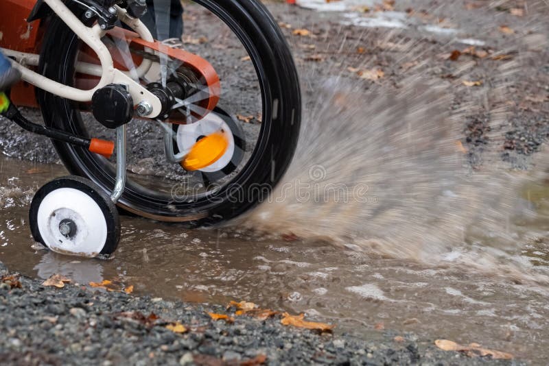 Riding on Bycicle on Puddle Learning To Bike. Stock Image - Image of ...