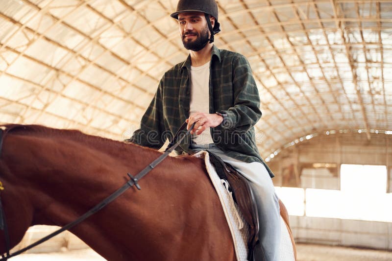 Riding the Horse. Young Man is in the Hangar Stock Image - Image of ...