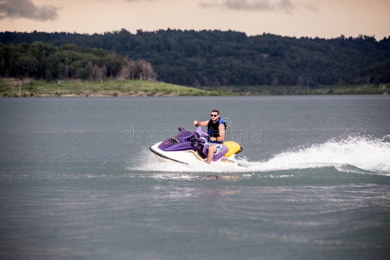 Riding a Jet ski. stock image. Image of people, water - 42074071