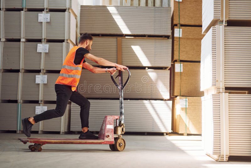 Riding the Platform Trolley. Storage Worker is in the Warehouse with ...