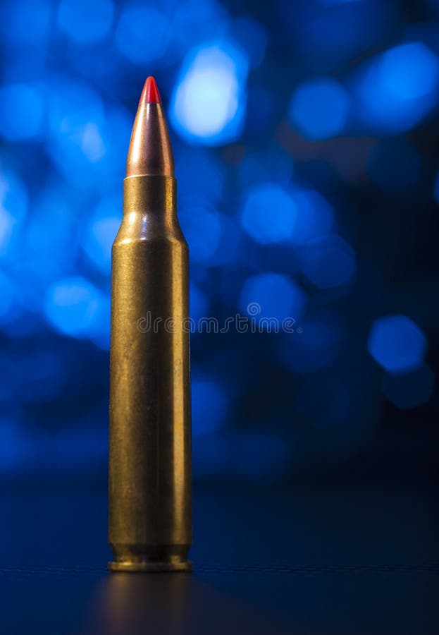 Rifle Ammo with Blue Behind Stock Photo - Image of blac, metal: 104266980