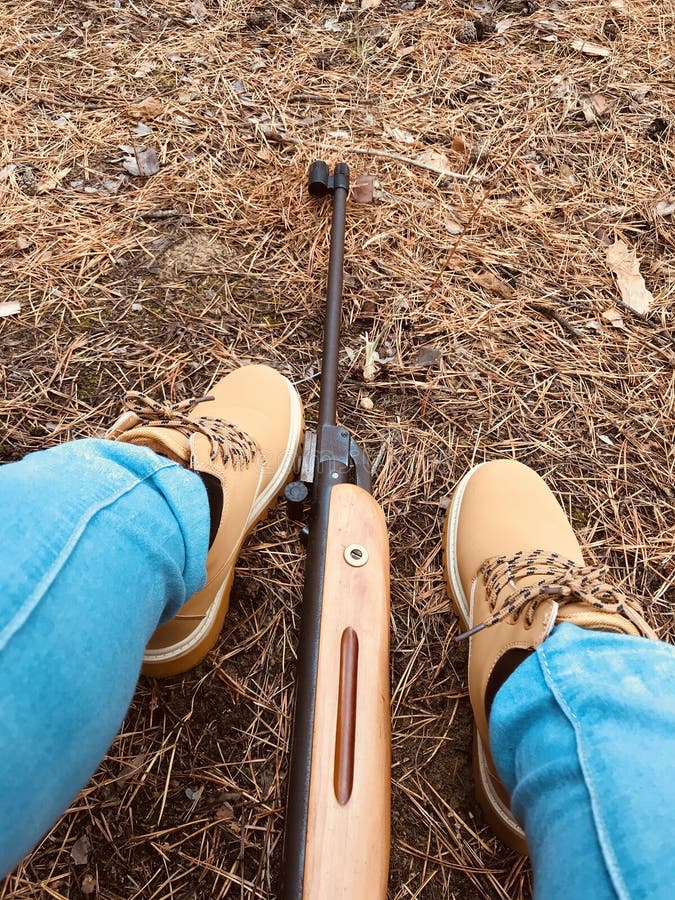 In the Autumn Forest is Shooting Cans with a Rifle. Stock Photo - Image ...