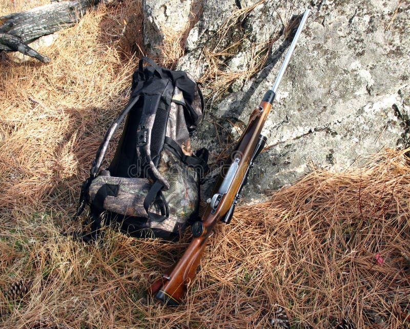 Rifle and backpack stock photo. Image of rock, moss, hunting - 45094016