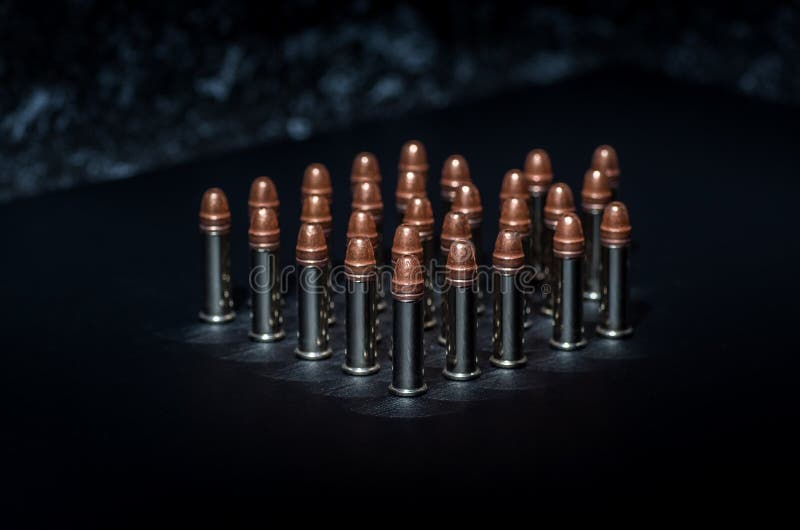 Rifle bullets over table stock image. Image of bullet - 67661243