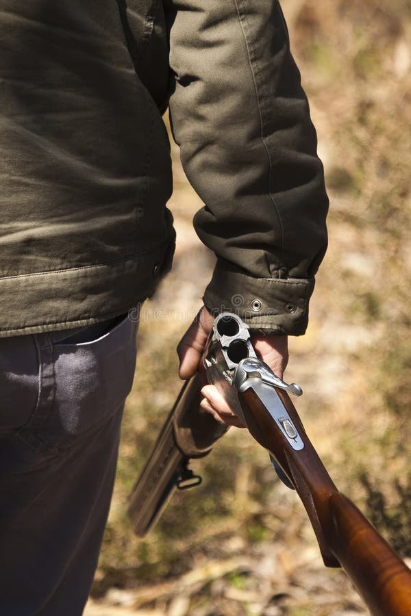 Rifle in hand stock photo. Image of landscape, pants - 13410476