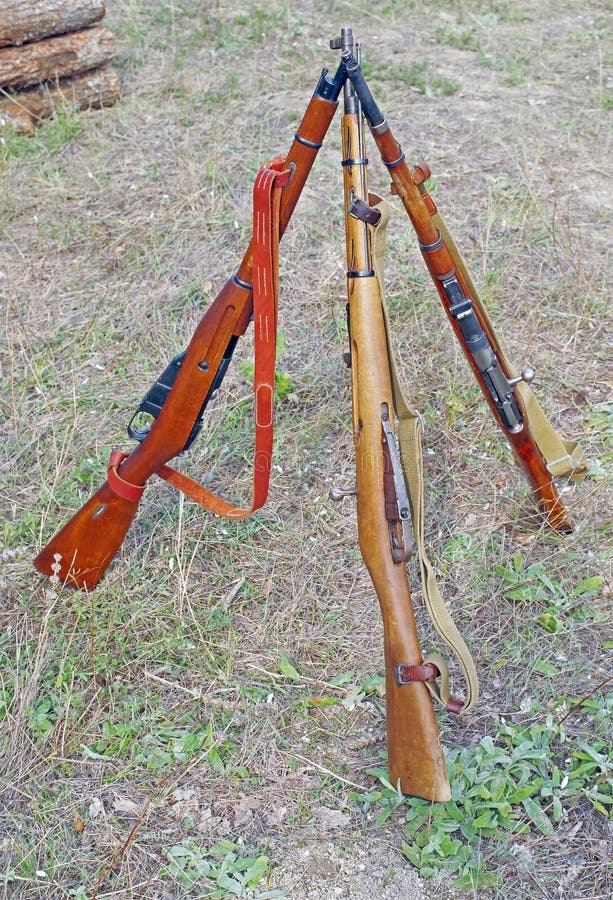 Rifles Arranged in a Pyramid Shape Stock Photo - Image of grass ...