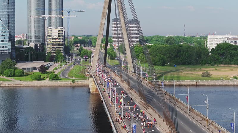 Riga Rimi Marathon 2024. Aerial View on Crowd of People Running through ... Riga Rimi Marathon 2024. Aerial View on Crowd of People Running through ...