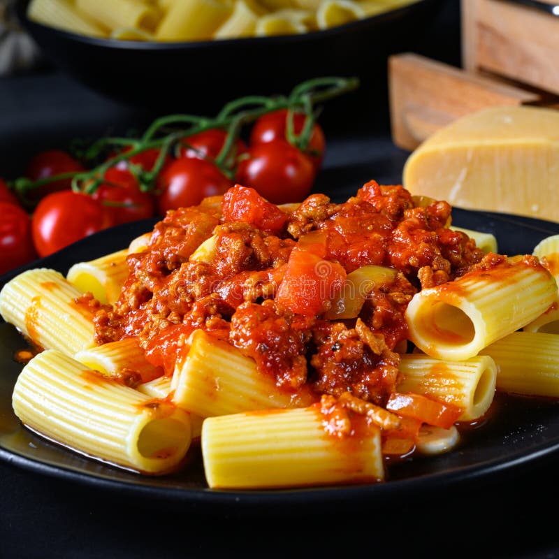 A Rigatoni Pasta with Bolognese Sauce and Fresh Basil Stock Photo ...