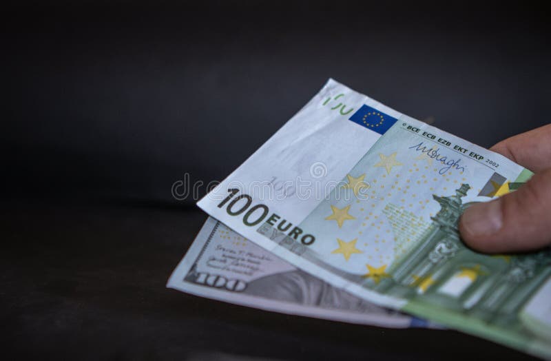Right Hand Holds Stack of 100 Dollar and 100 Euro Banknotes on Black ... Right Hand Holds Stack of 100 Dollar and 100 Euro Banknotes on Black ...