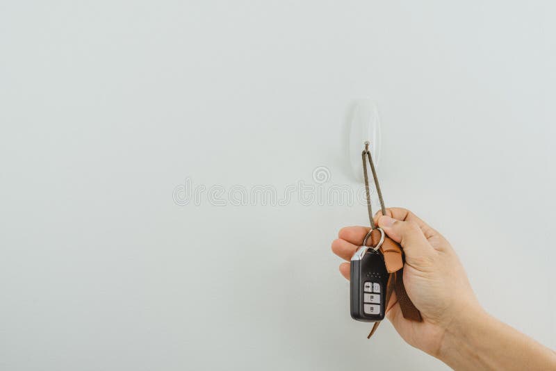 The Right Hand is Picking Up or Taking the Keychain, Car Key from ...