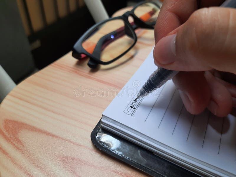 Right Hand Writing on a Ruled Notebook Over a Small Table Stock Photo ...