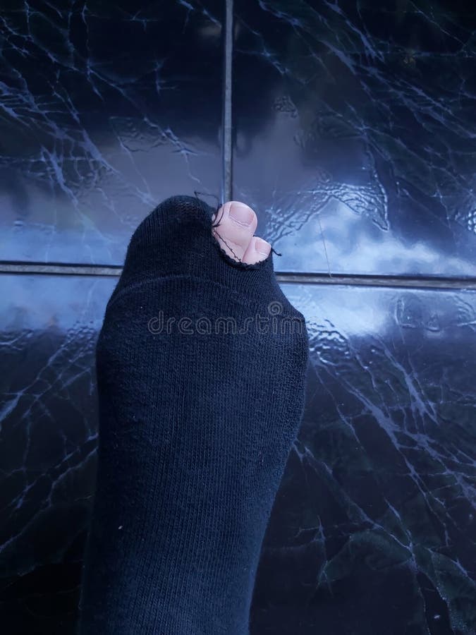 The Right Toe that is Visible from the Black Holey Sock Stock Photo ...