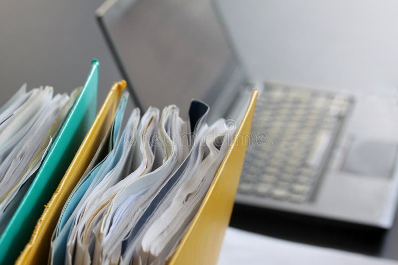 Ring Binders Filled with Papers in Front of Laptop Computer on Office ...