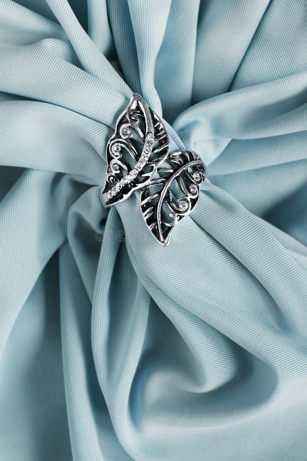 Ring on blue silk stock image. Image of detail, jewelry - 107009611
