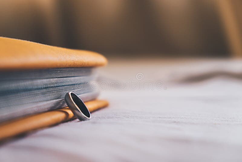 Ring and a book on the bed stock photo. Image of dark - 173307498