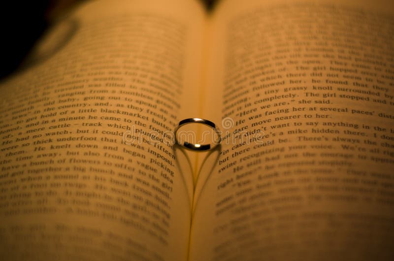 Ring in the Book with a Heart-shaped Shadow Stock Image - Image of ...