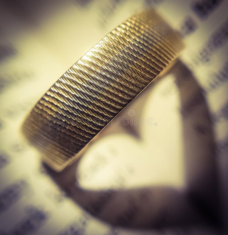 Ring Casting a Heart-shaped Shadow in a Book Stock Image - Image of ...