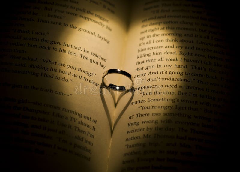 Ring Casting a Heart-shaped Shadow in a Book Stock Image - Image of ...