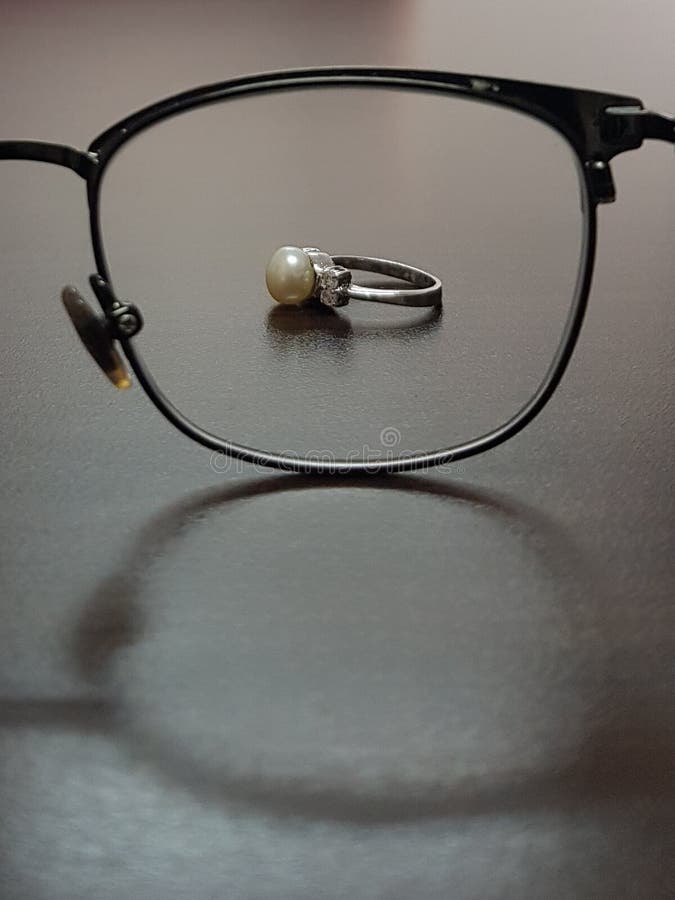Ring in frame in glasses stock photo. Image of necklace - 259949568