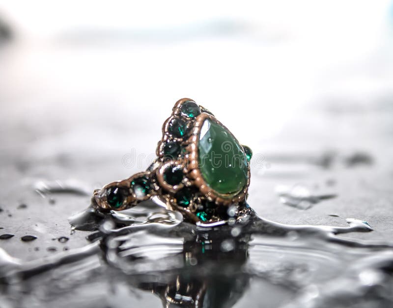 Ring with Green Stone in the Water Stock Image - Image of black ...
